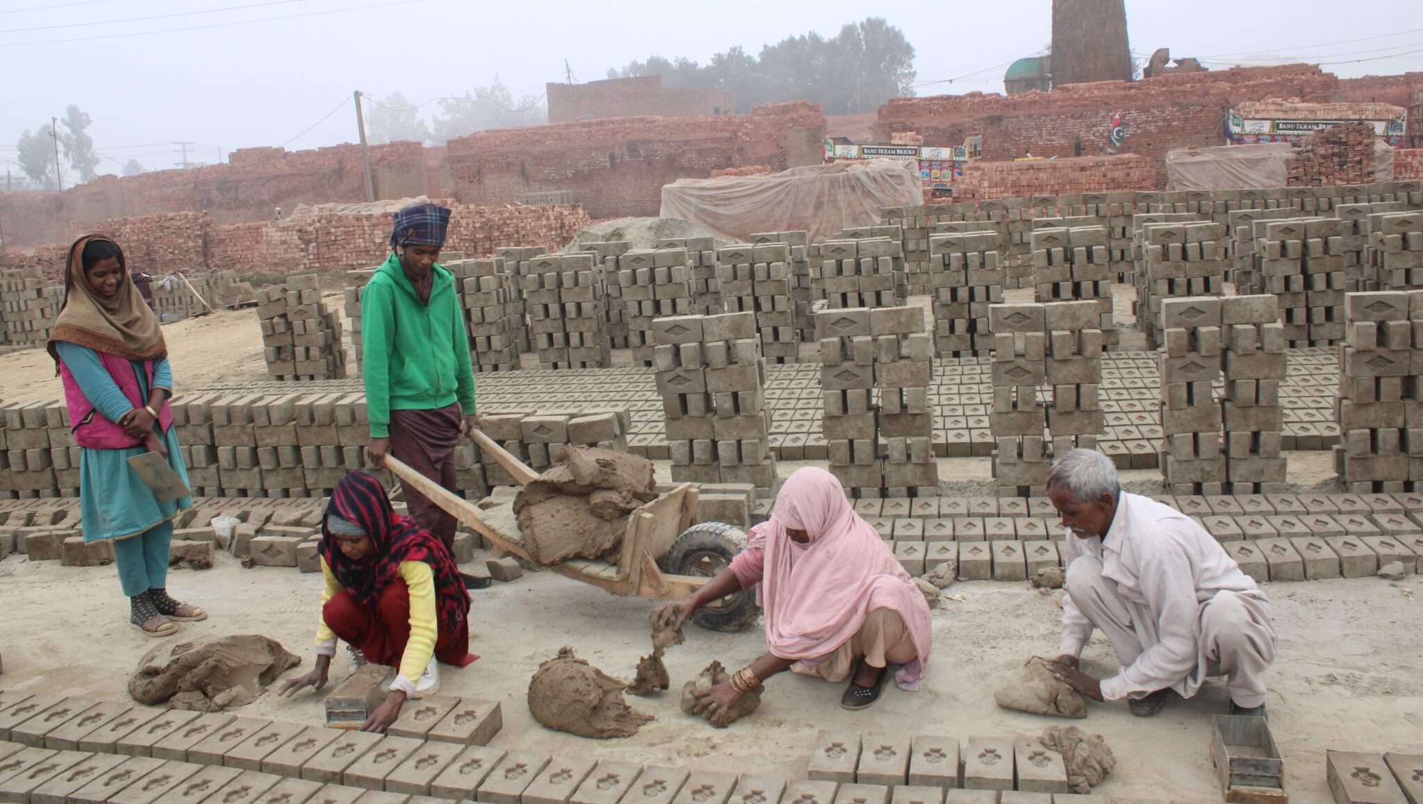 Azeeb and his family working in the kiln.