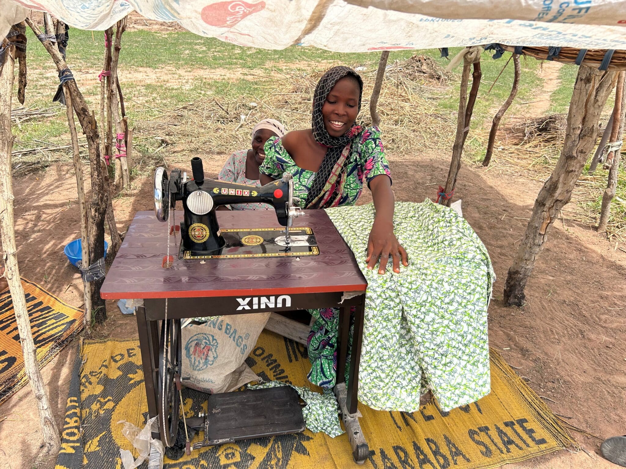Marta, Suzanne's daughter sews a dress in Nigeria